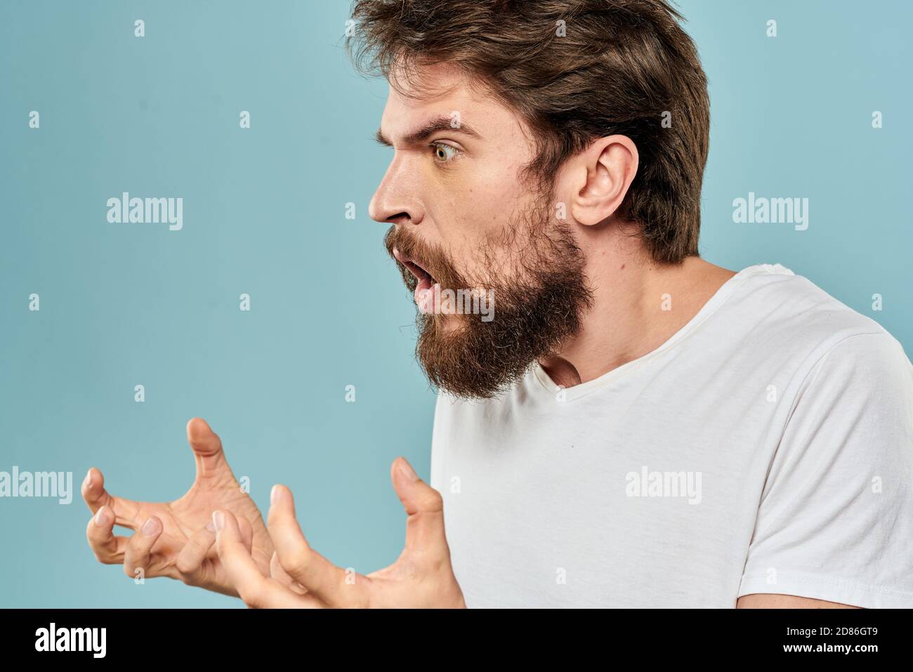 Bearded man emotions facial expression gestures hands close-up blue ...
