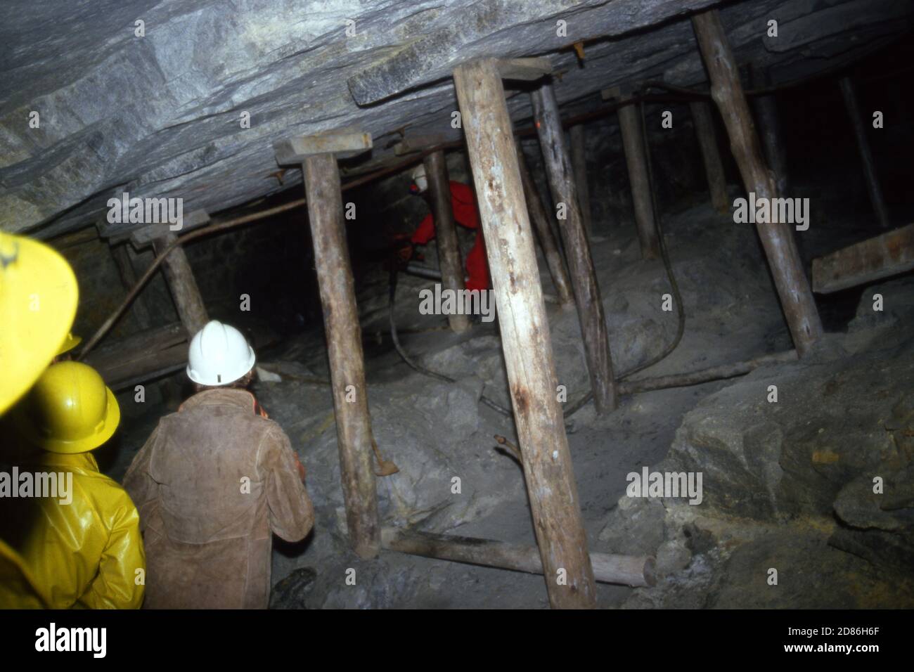 Guide explaining the workings of the mine to visitors underground at ...