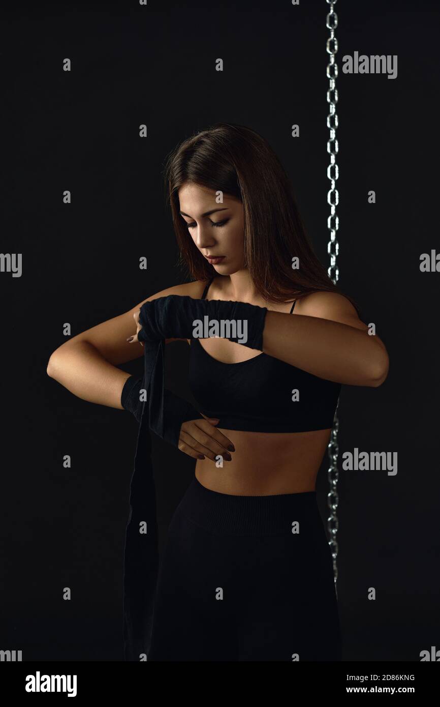 Woman boxer wearing black strap on wrist. female boxer preparing for ...