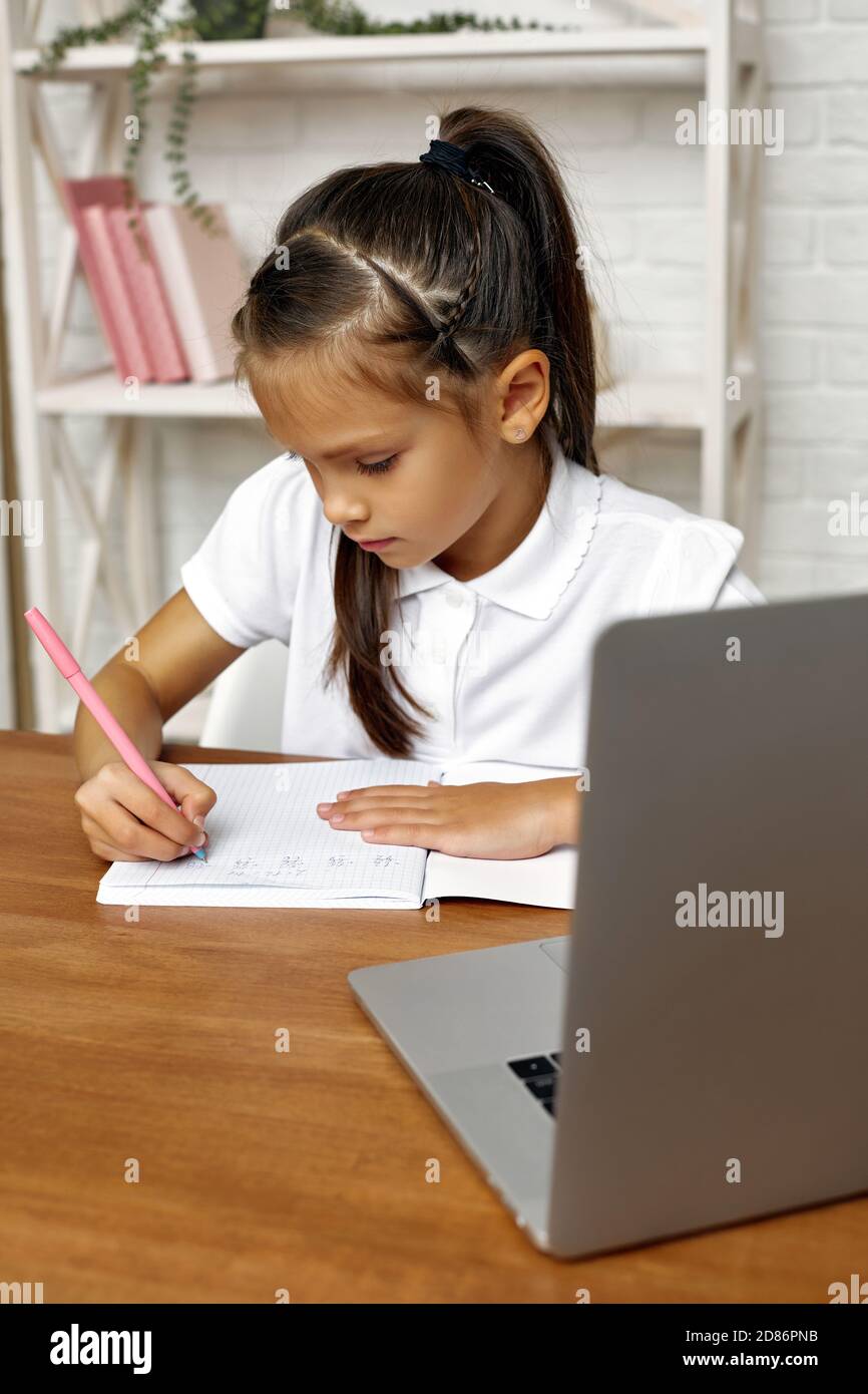 cute little child girl using computer for studying online e-learning ...