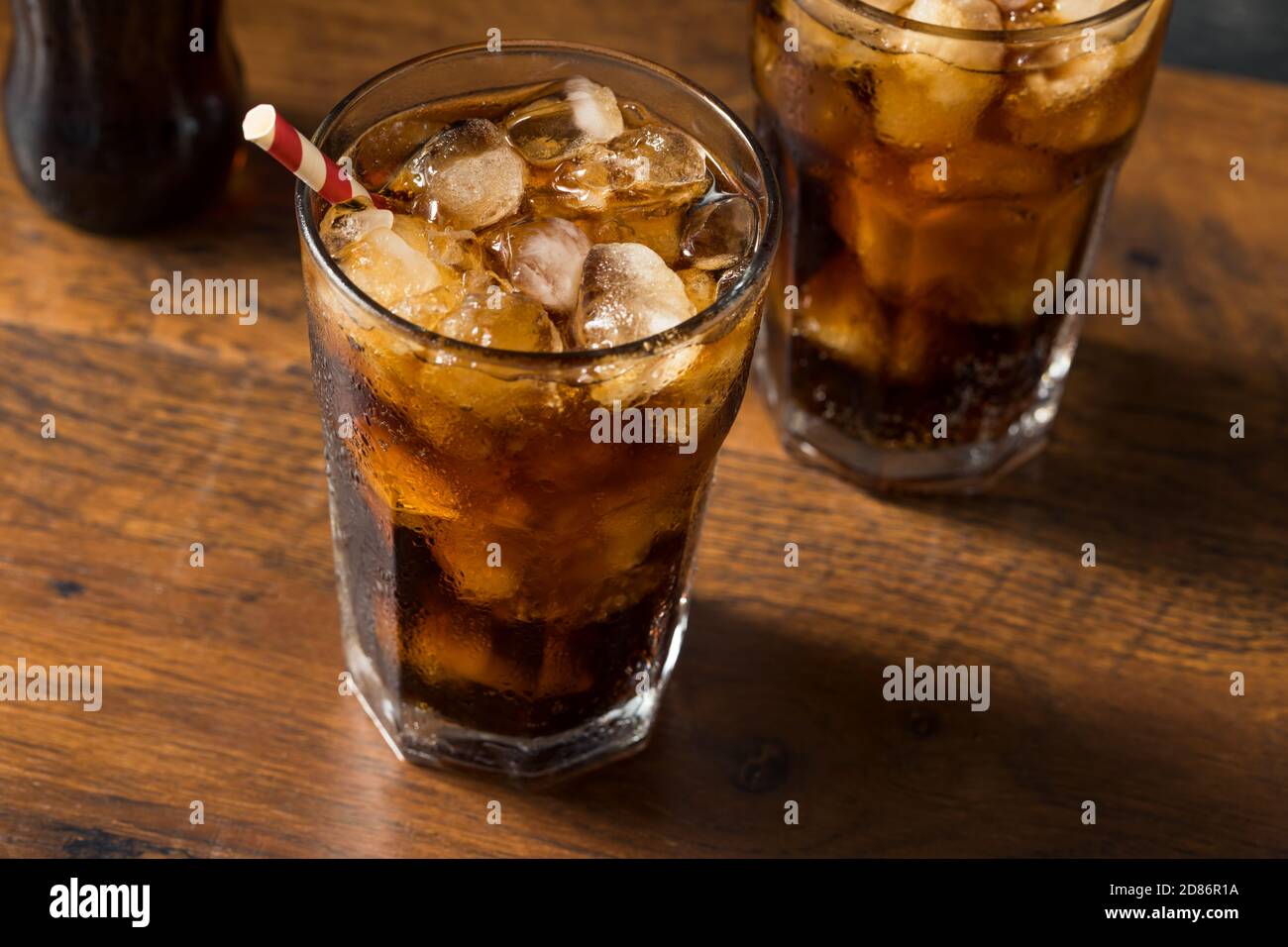 Refreshing Cold Dark Cola Soft Drink with a Straw Stock Photo - Alamy