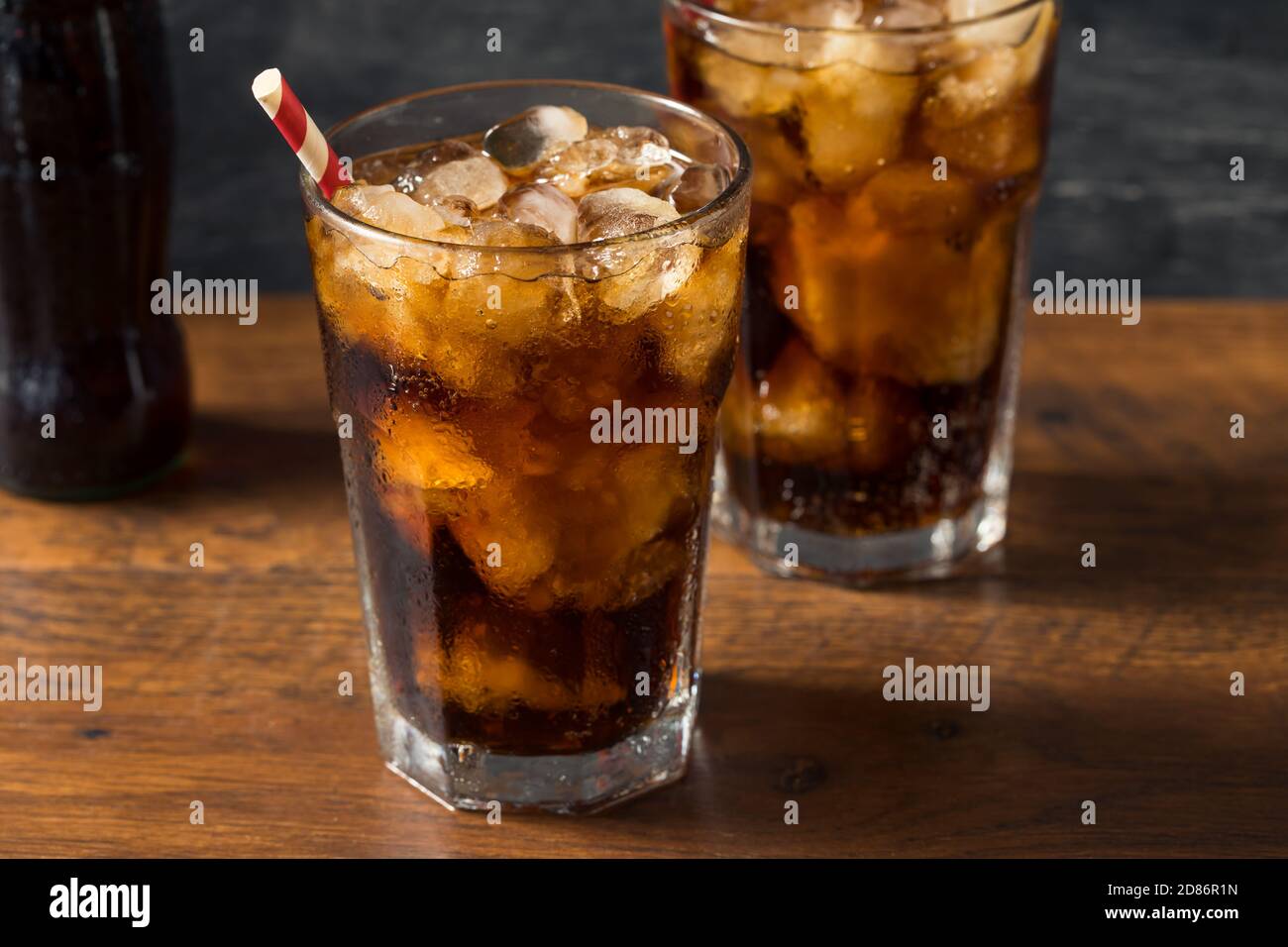 Refreshing Cold Dark Cola Soft Drink with a Straw Stock Photo - Alamy