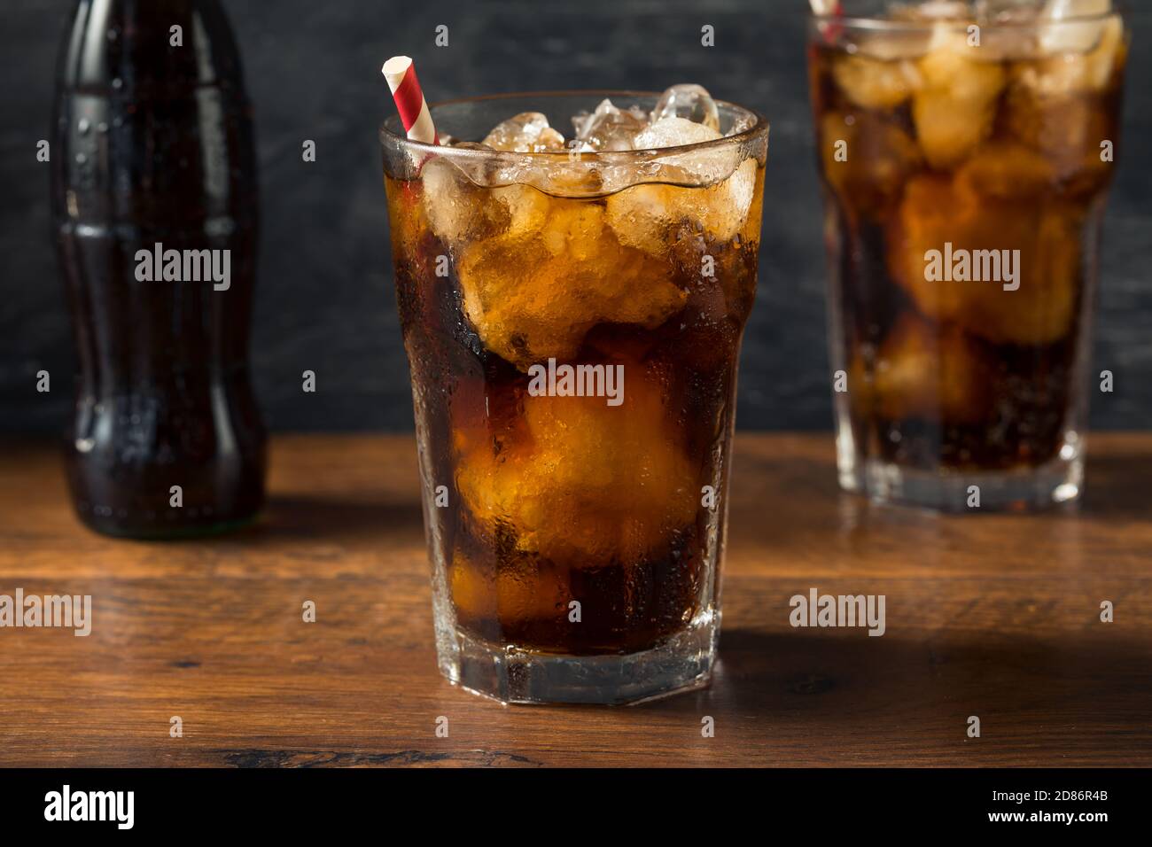 Refreshing Cold Dark Cola Soft Drink with a Straw Stock Photo - Alamy