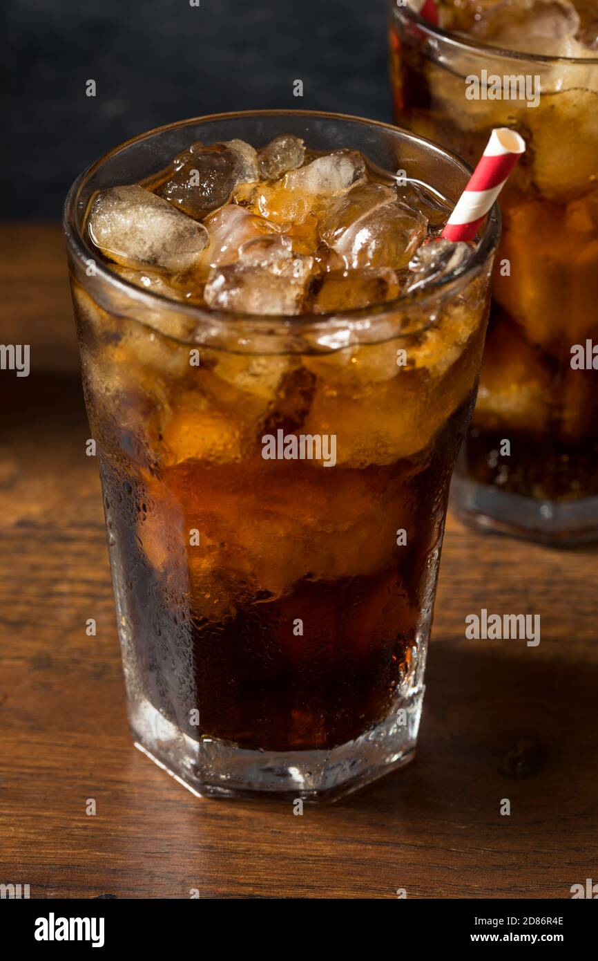 Refreshing Cold Dark Cola Soft Drink with a Straw Stock Photo - Alamy