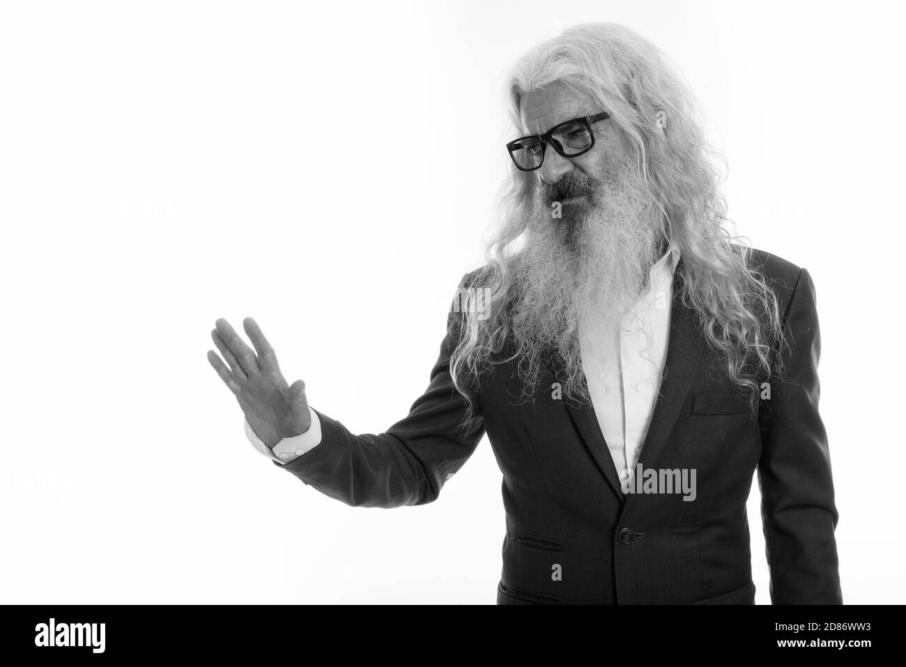 Studio shot of senior bearded businessman looking disgusted while ...