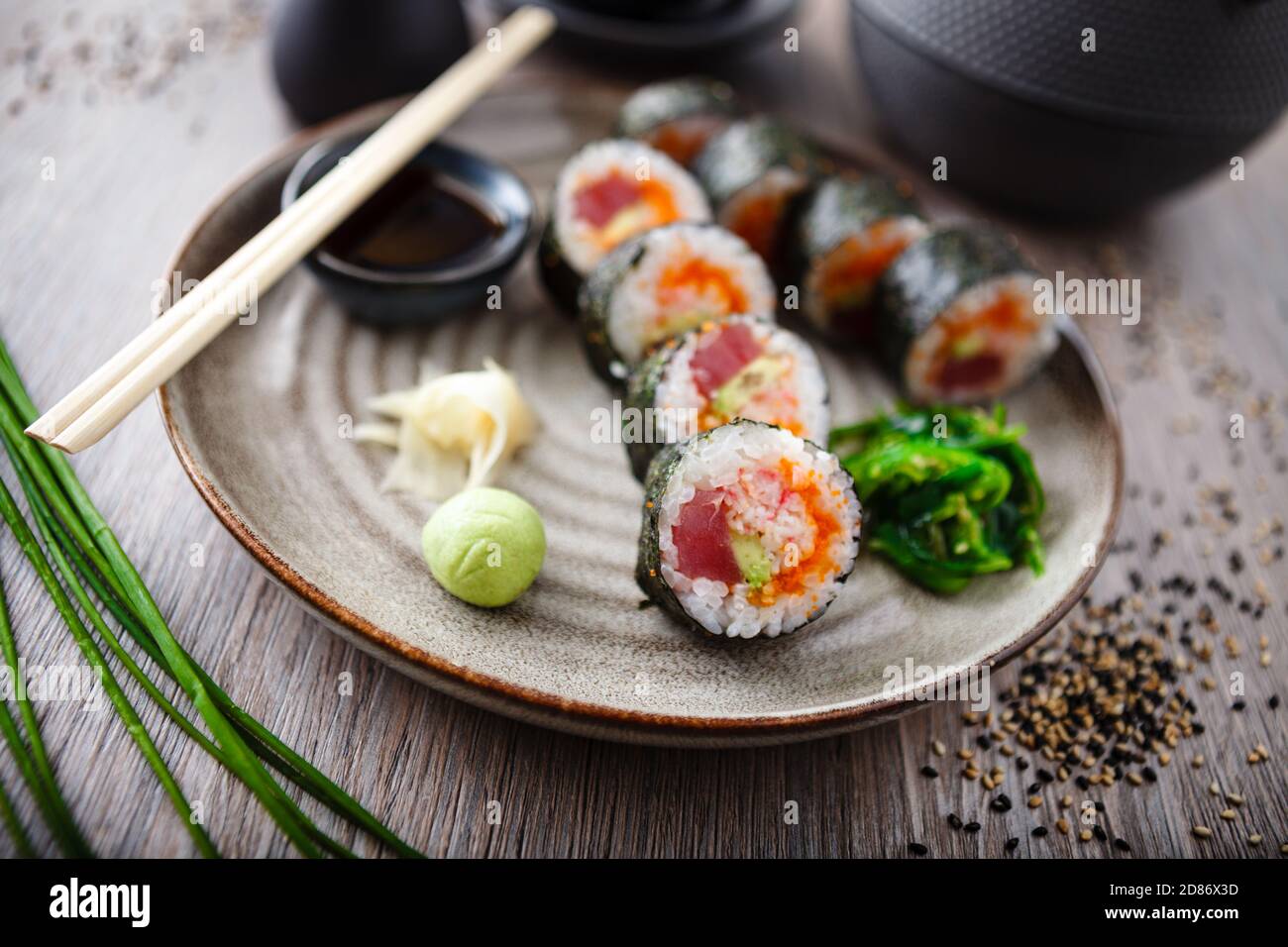 Sushi maki rolls with tuna, flying fish caviar, crab, avocado on a ...