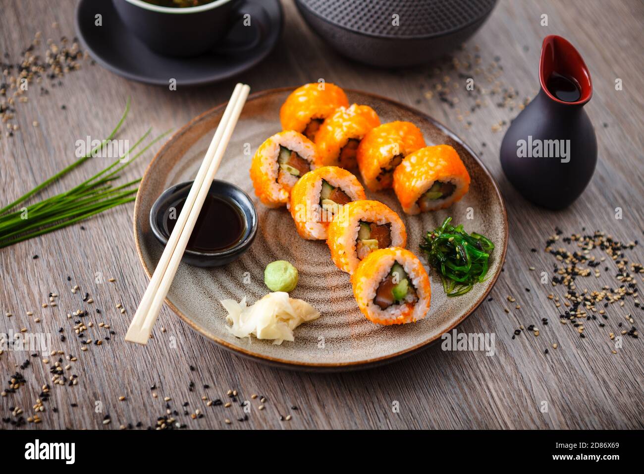 Sushi maki rolls with salmon, avocado, cucumber, flying fish roe on a ...