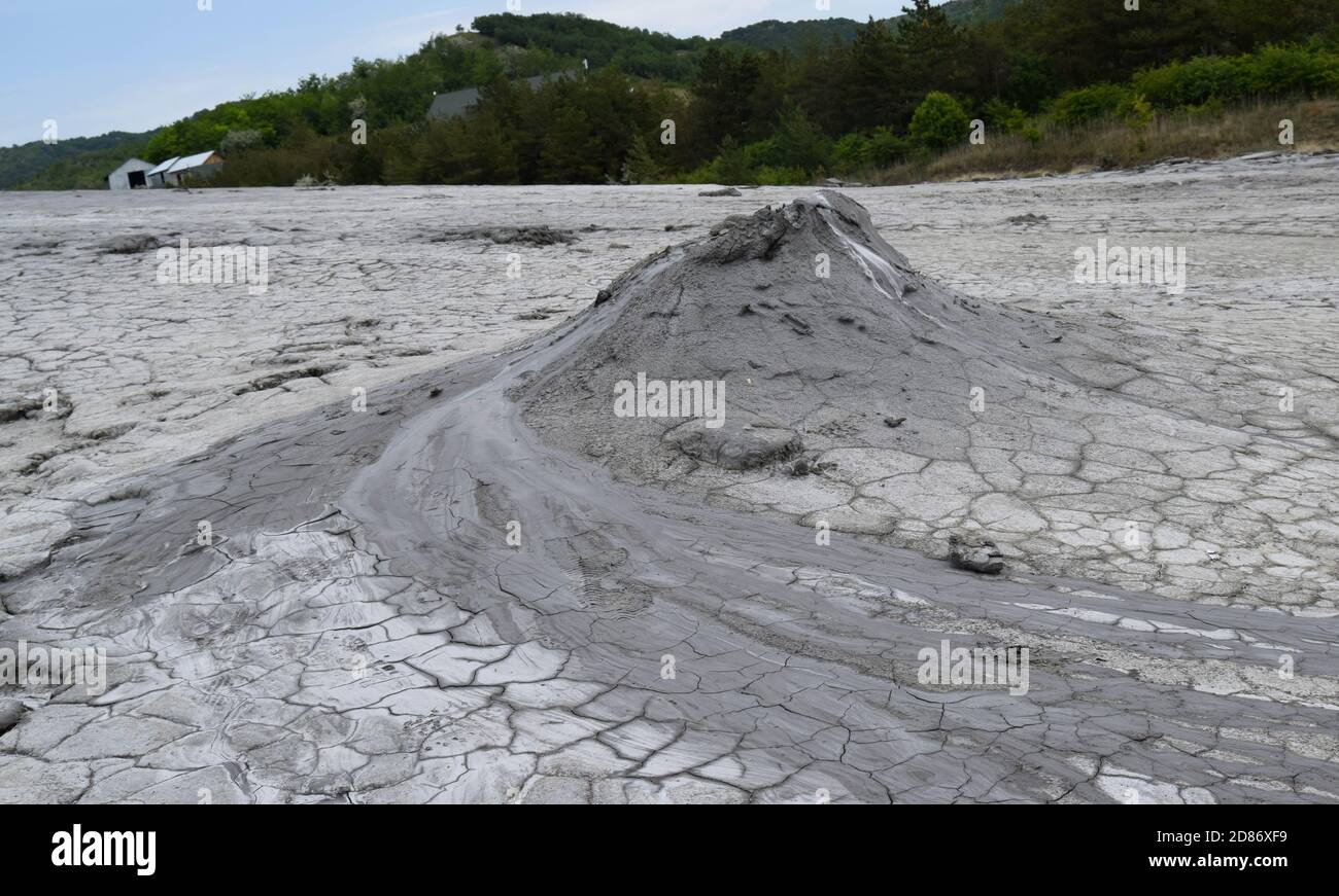 Close up view on crater of mud volcano. Slow flow of underground mud ...