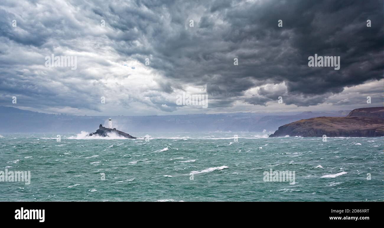 Dramatic storm with waves crashing over Godrevy Lighthouse in Cornwall ...