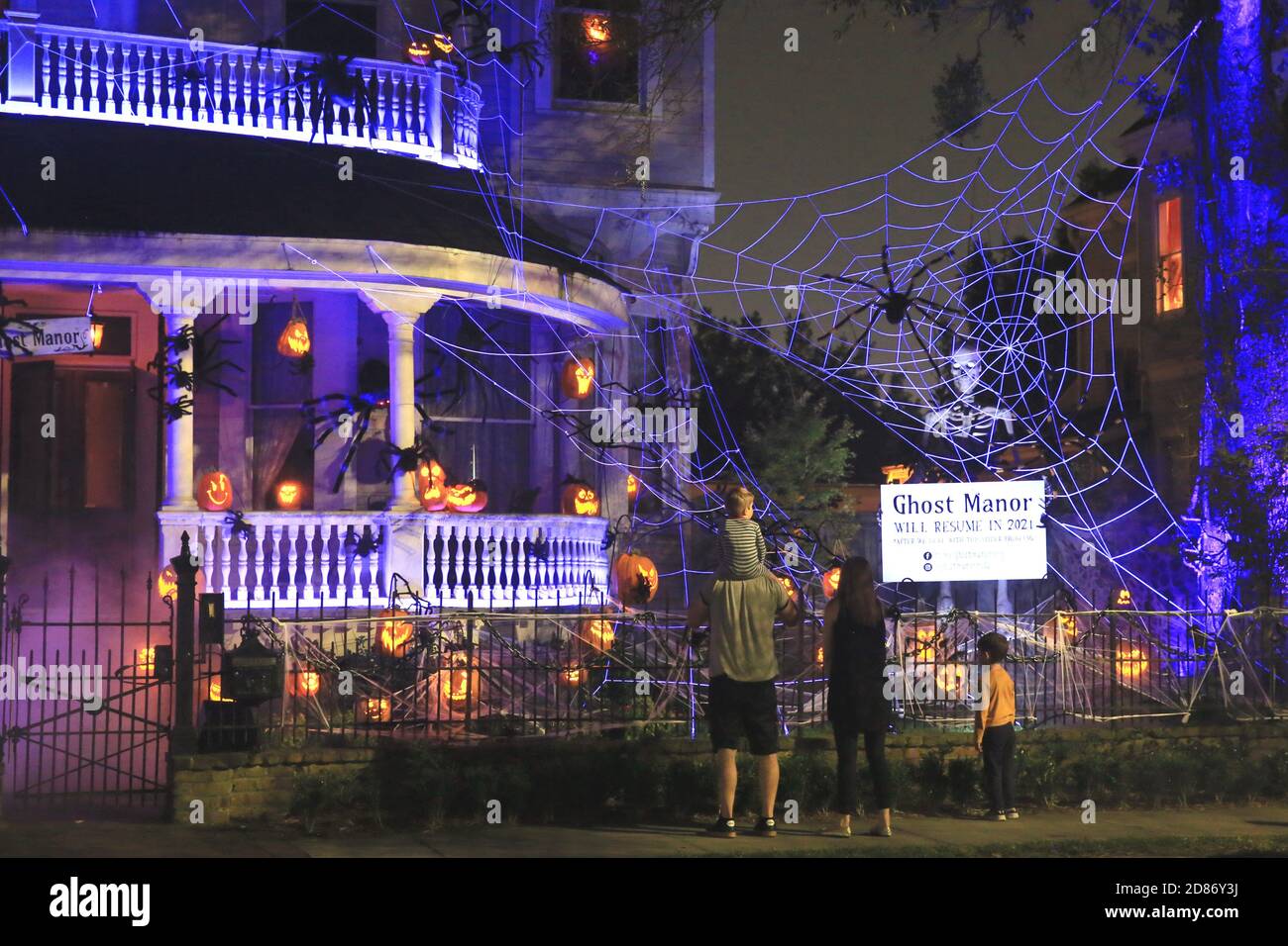 New Orleans, USA. 26th Oct, 2020. Pedestrians look at the "Ghost Manor ...