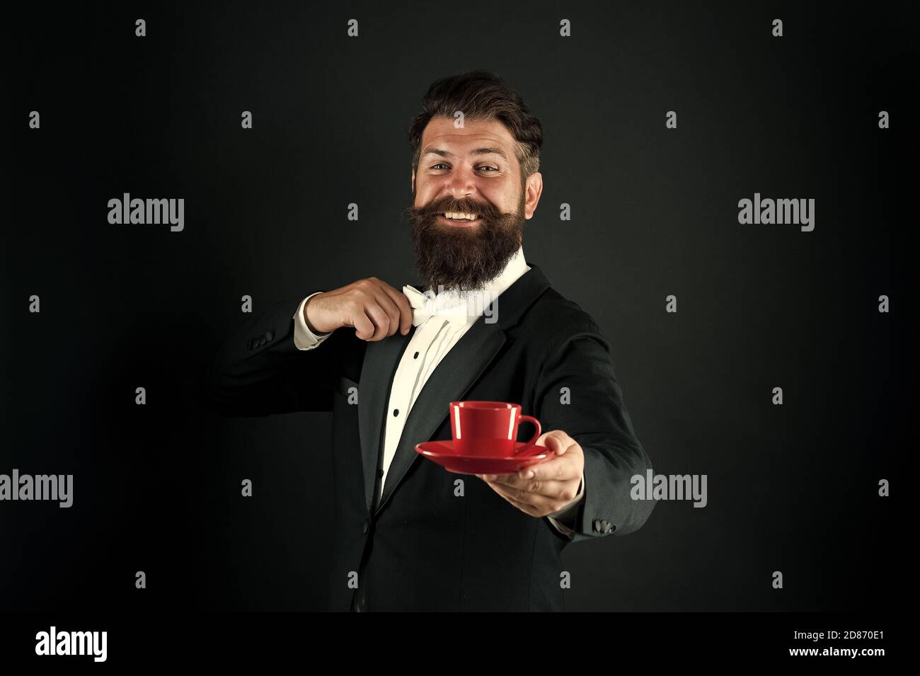 Art of serving tea. Happy waiter serve tea black background. Bearded ...