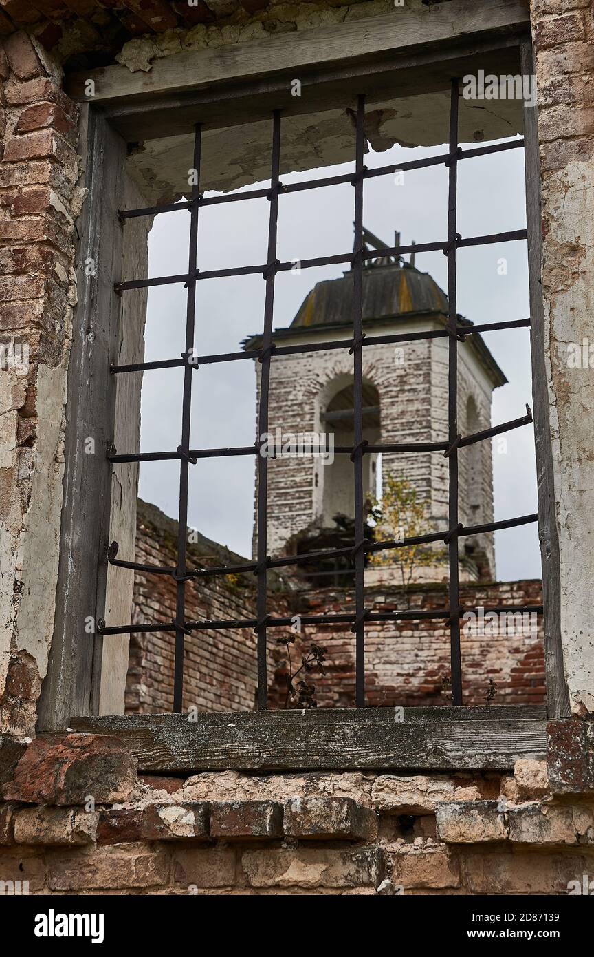 View of the ruined bell tower through a window with bars Stock Photo ...