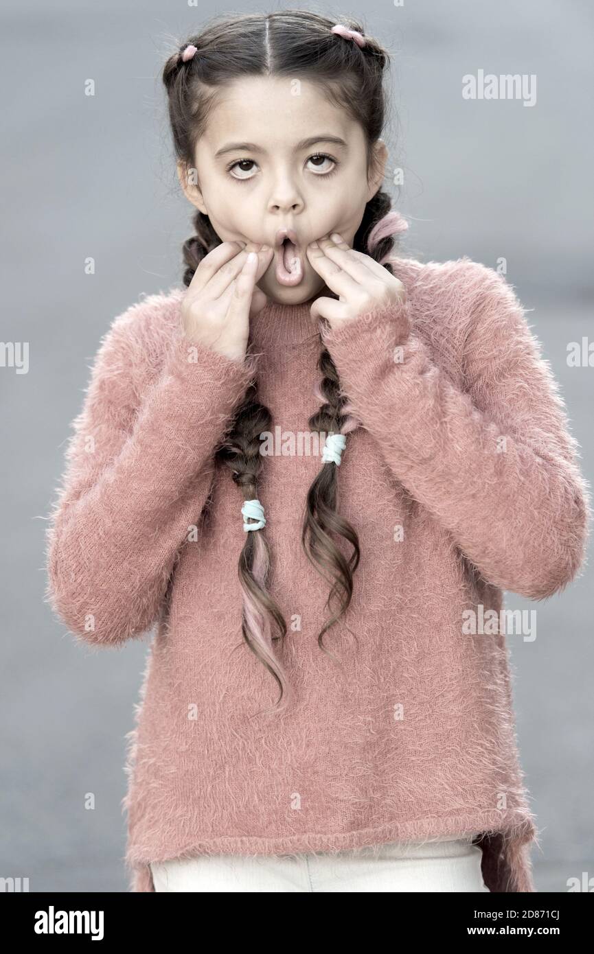 Kid with long braided hair make bored grimace face. So boring. Bored ...