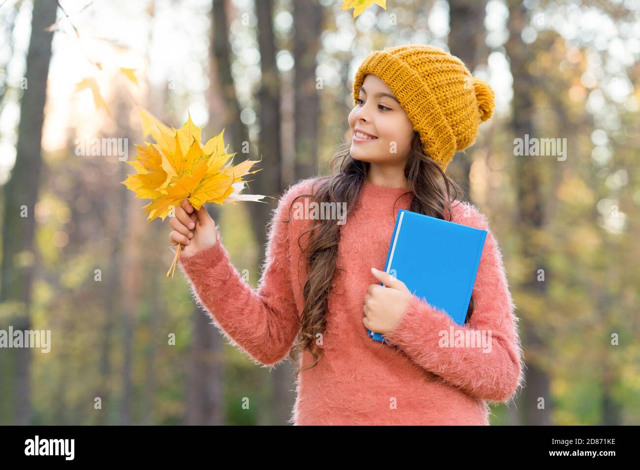 Awesome autumn activities for school. Happy kid hold book and autumn ...