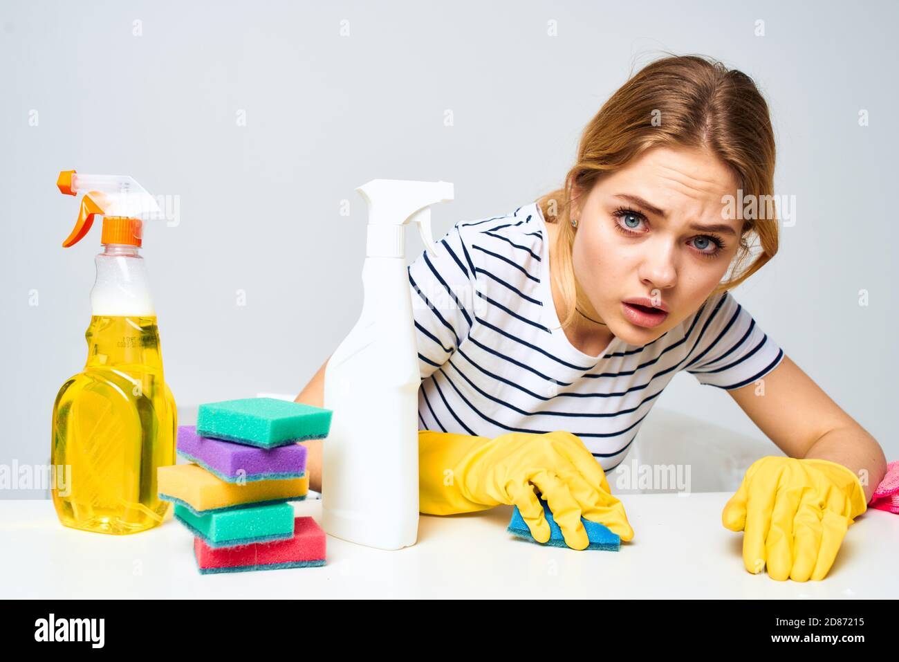 A cleaning lady sits at a table providing housekeeping services light ...