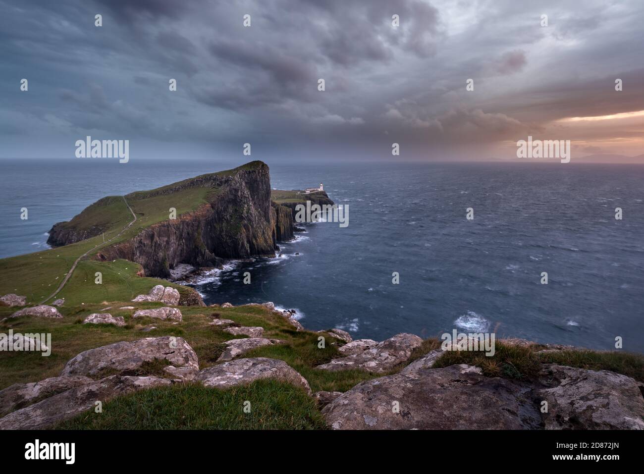 Dark and moody storm clouds over Neist Point lighthouse on the Isle of ...