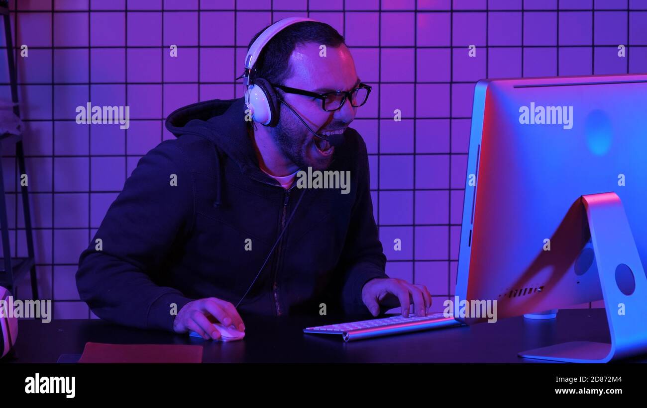 Evil lough of angry gamer while playing on the computer. Emotion Stock ...