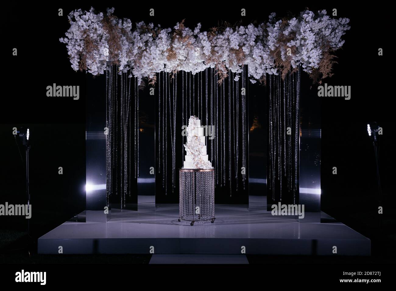 Wedding cake in the center of the scene decorated with brilliants and ...