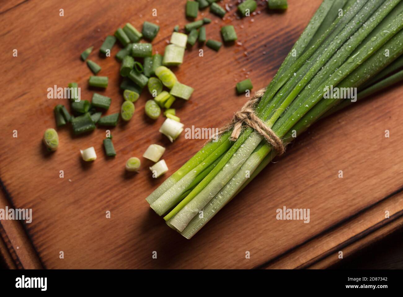 Chives feathers chopped on a board, top view Stock Photo - Alamy