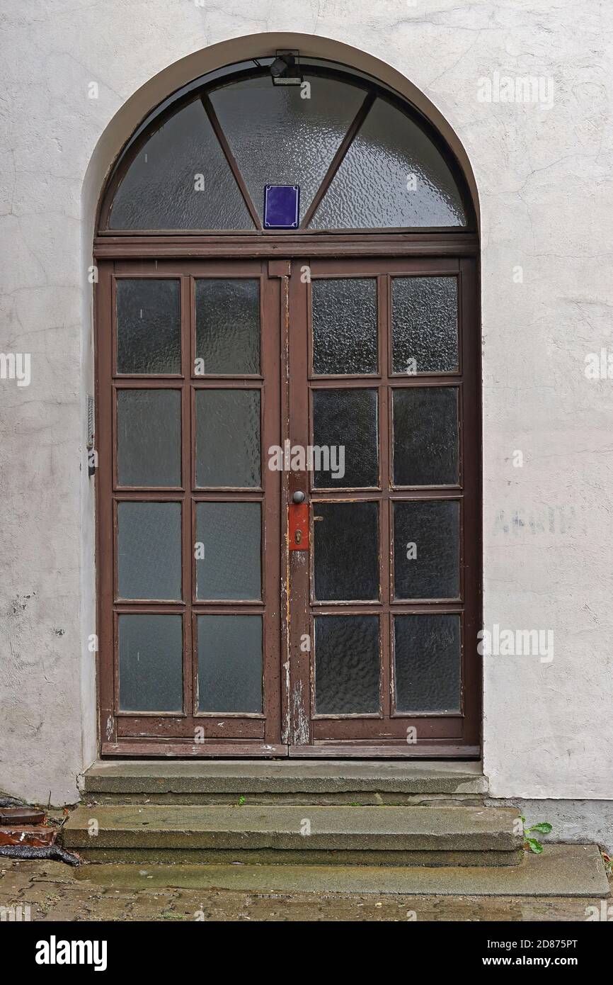 Closed arch glass double doors house entrance Stock Photo - Alamy