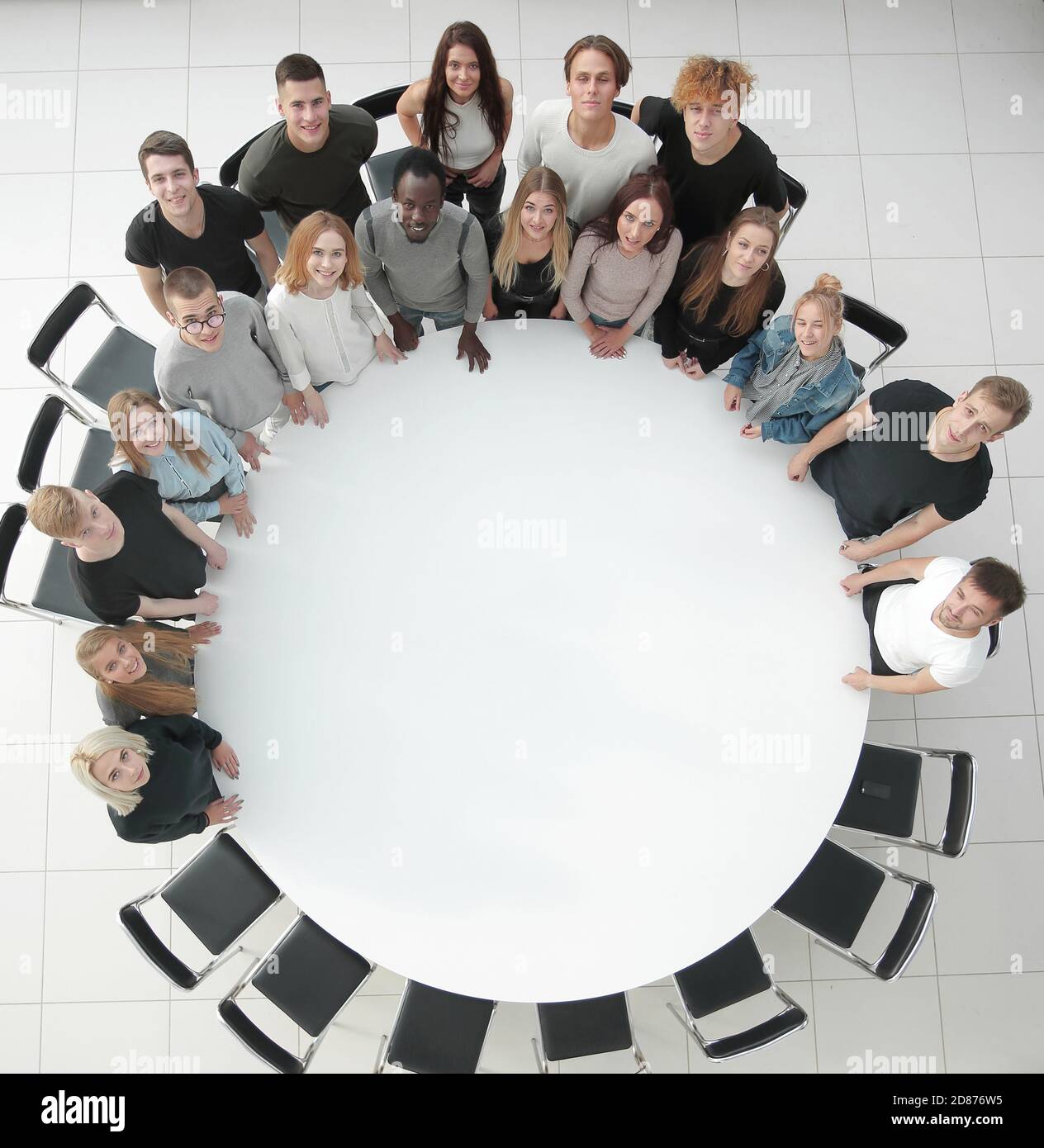 top view. group of young people standing near a large round table Stock ...