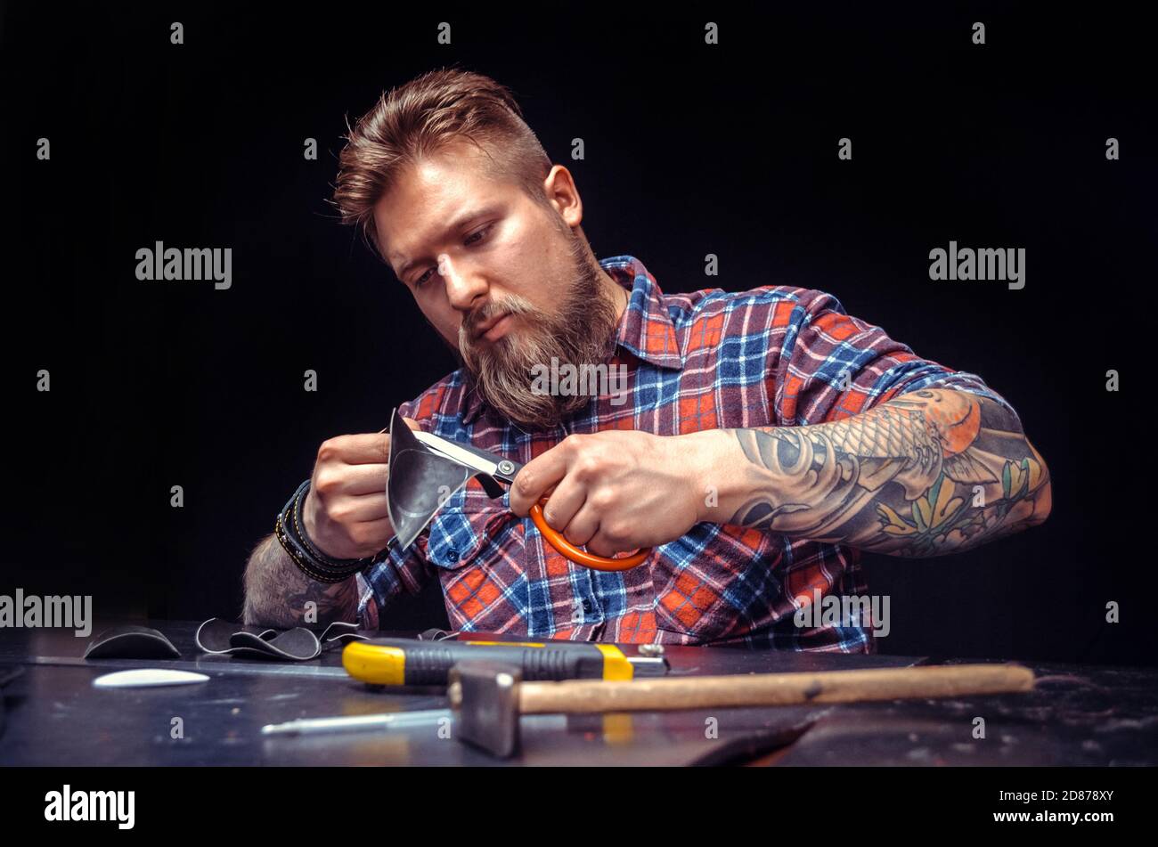 Leather Skinner working as artisan at his work area Stock Photo - Alamy