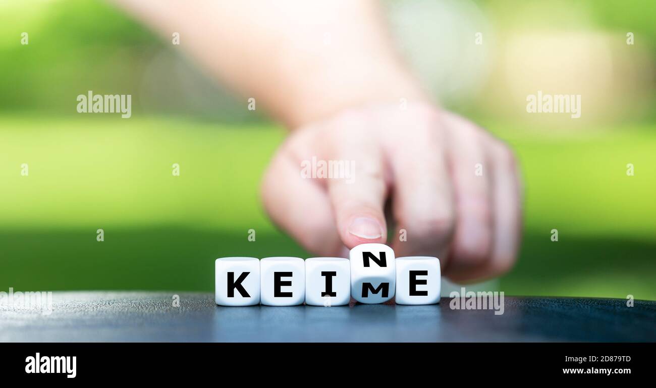 Symbol for fighting germs. Hand turns dice and changes the German word ...