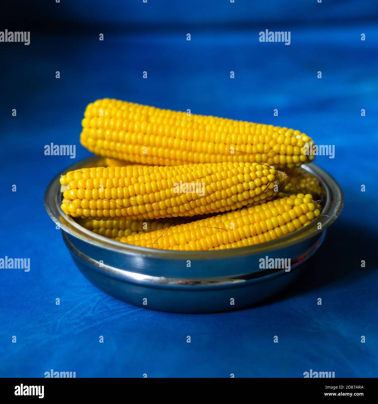 Boiled corn on blue hi-res stock photography and images - Alamy
