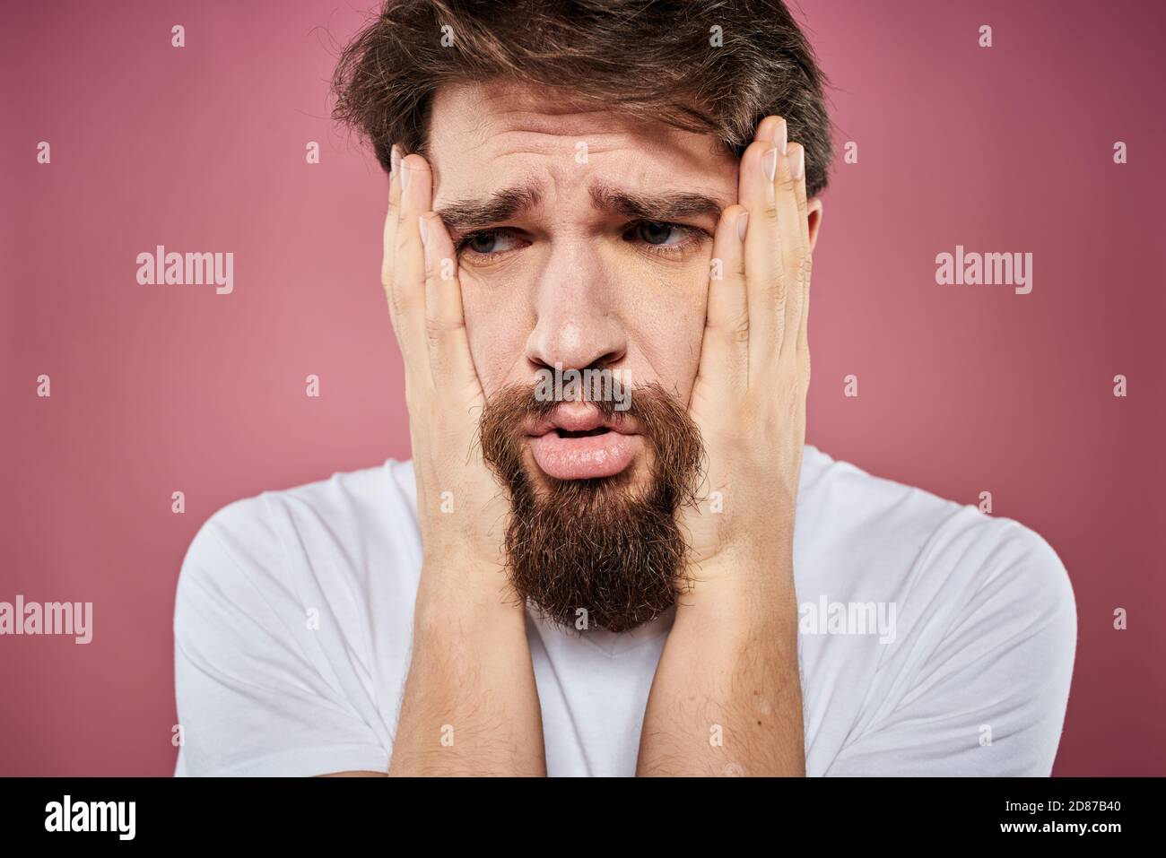 bearded man in white t-shirt emotions displeased facial expression ...