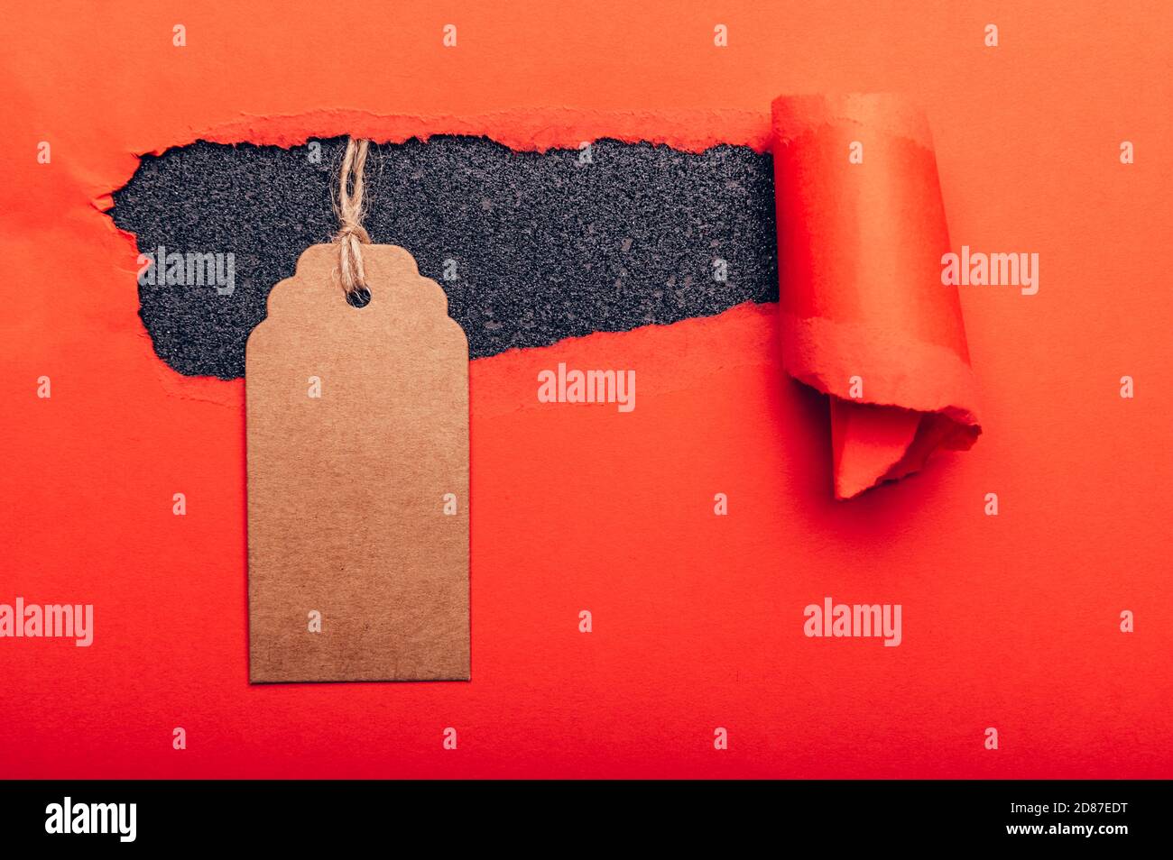 Gift Tag on red torn paper Stock Photo - Alamy