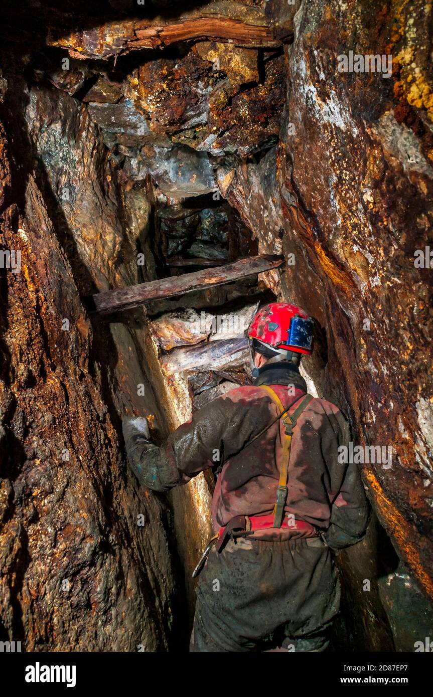 Timber stemples holding up waste rock in the roof of a passage in Odin ...