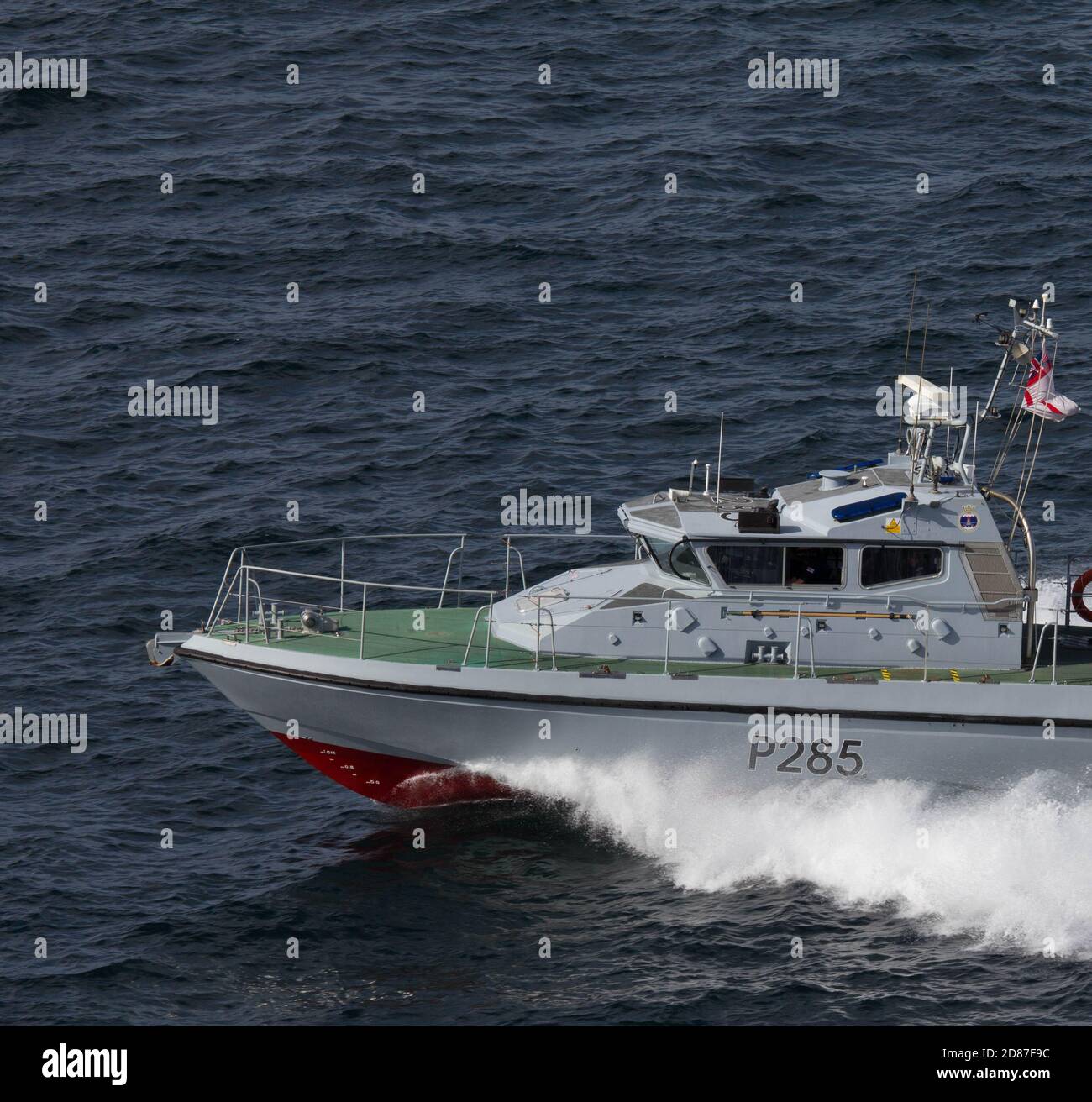 Royal Navy fast patrol boat underway at speed across a dark sea of ...