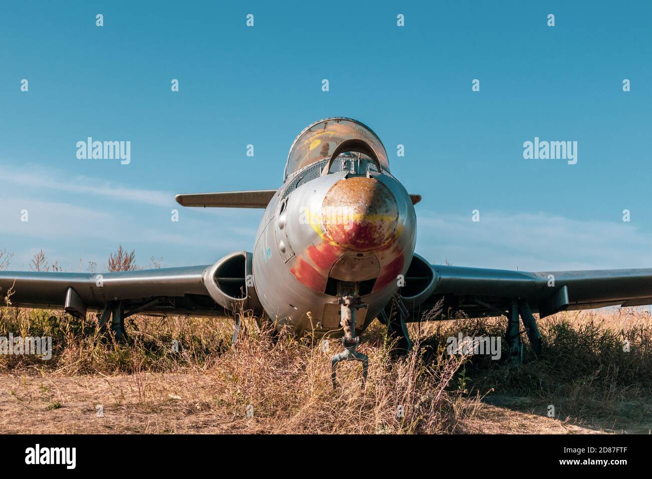 Old retro military plane front view on blue clear vivid autumn sky in ...