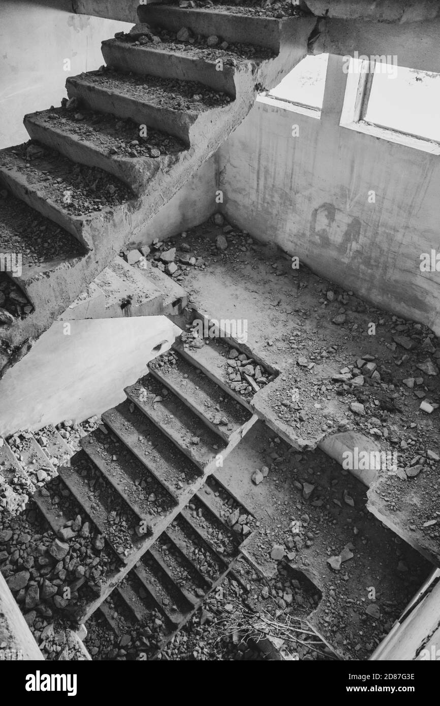 Black and white weathered concrete staircase inside abandoned ruined ...