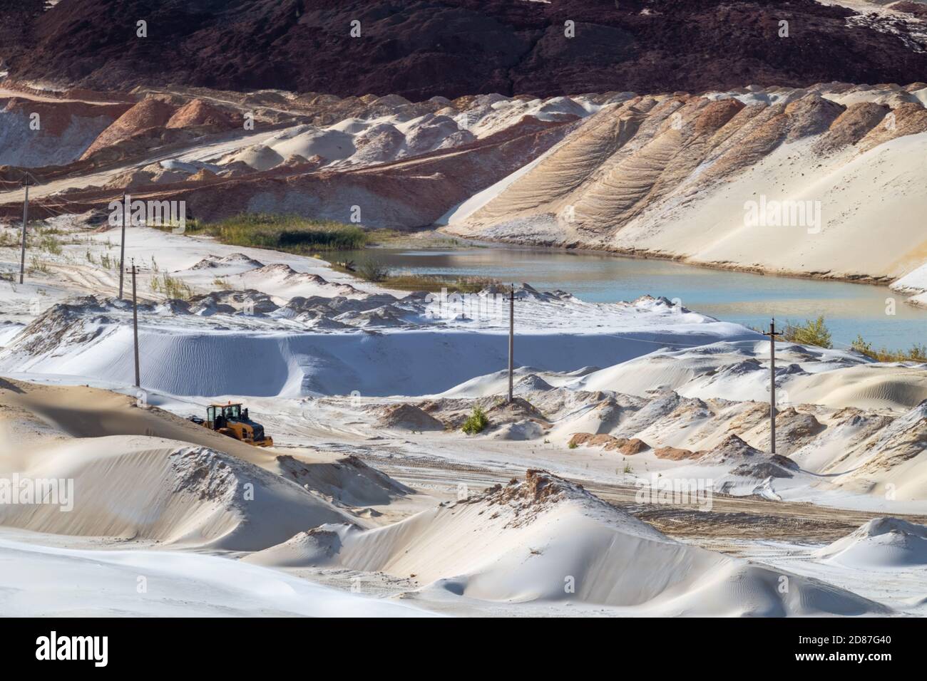 Sand extraction with machinery excavator at quartz quarry. Sand dunes ...
