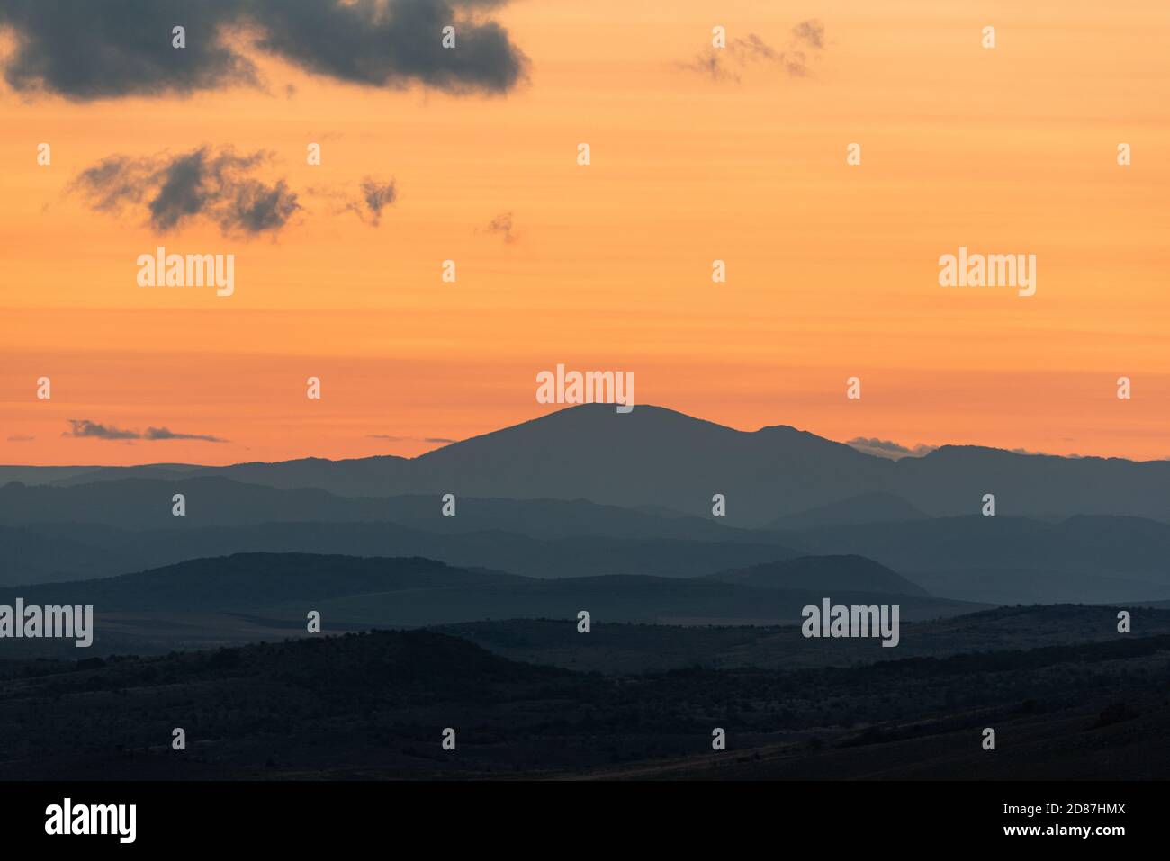 Landscape sunset colors over mountains and hills orange red yellow blue ...