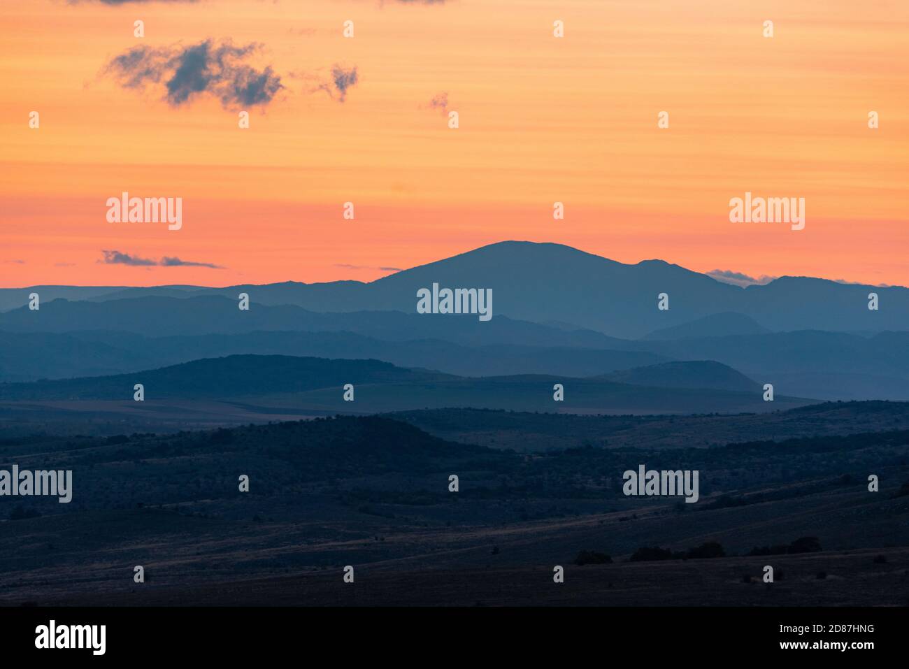 Landscape sunset colors over mountains and hills orange red yellow blue ...