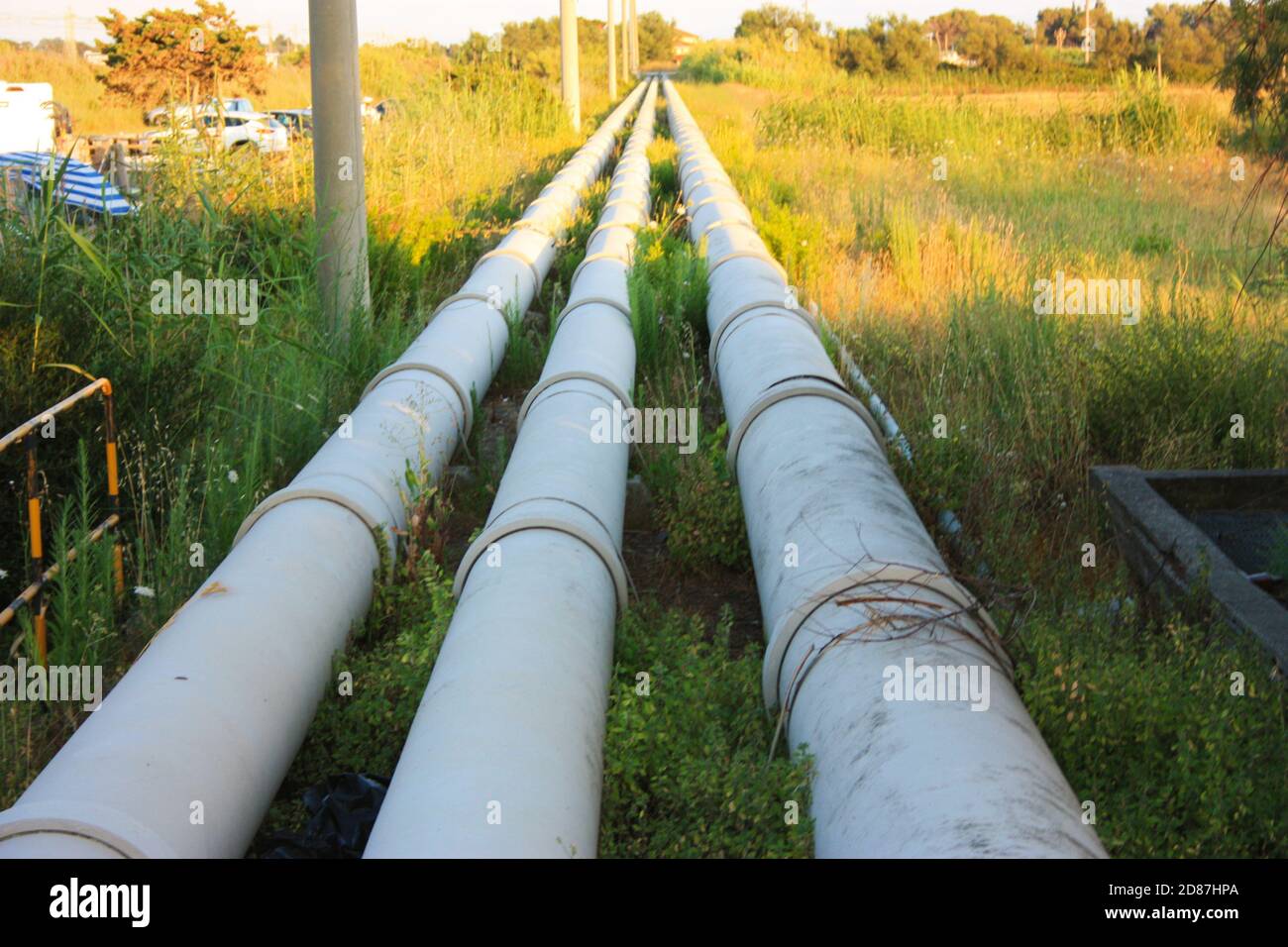 three long parallel large diameter steel pipes of outdoor pipeline in ...