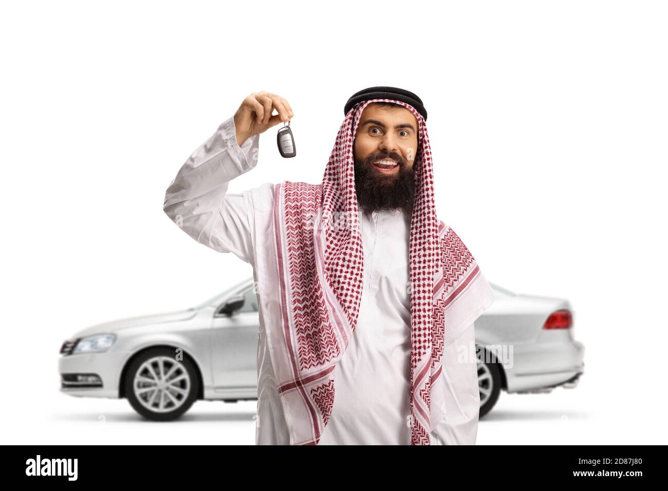 Happy arab man with car keys posing in front of a silver car isolated ...