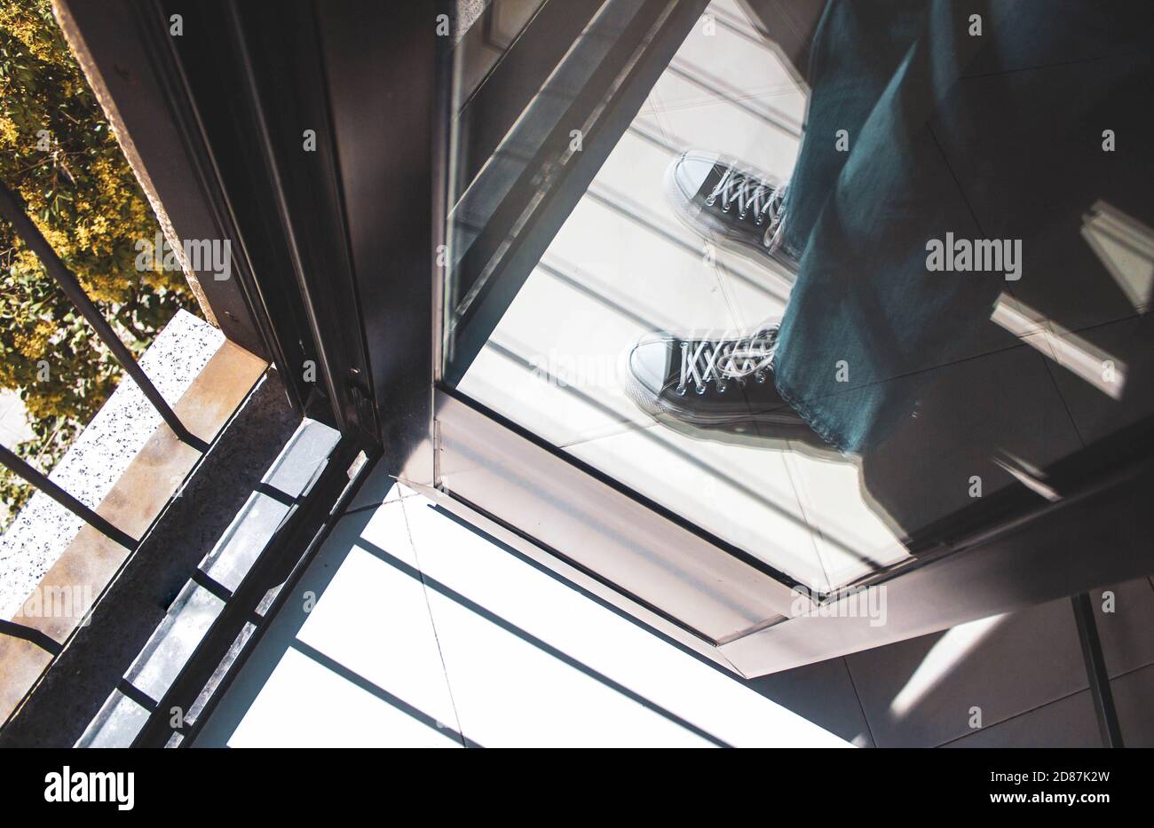 woman legs reflected in a window next to the balcony Stock Photo - Alamy