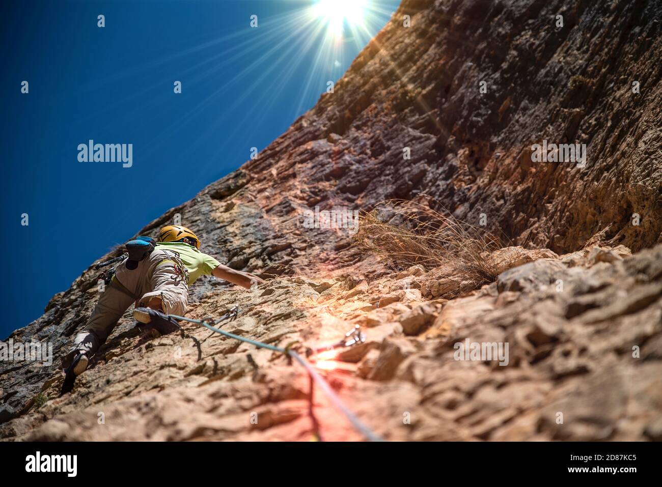 Climber from a low angle view point with sun reflections Stock Photo ...