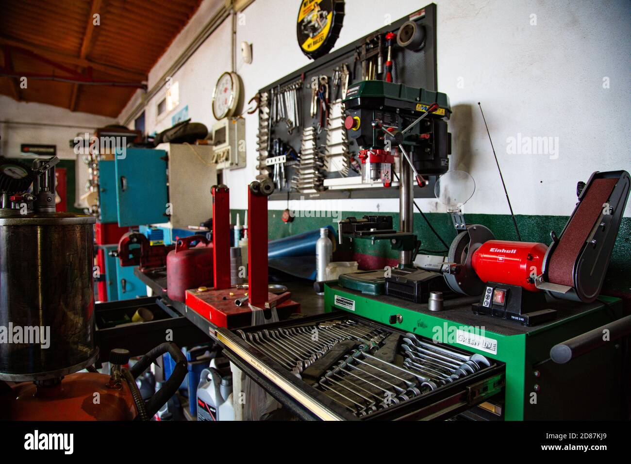 Table, box and panel of tools in mechanics workshop Stock Photo - Alamy