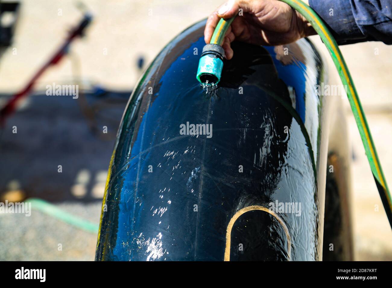 Man checking patch placement with water Stock Photo - Alamy