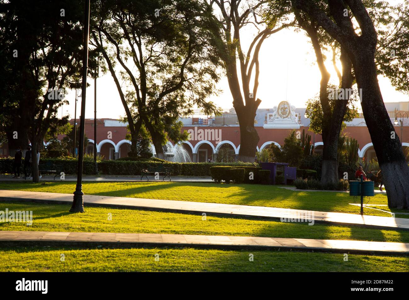 Golden hour over green lawn of public park in Cholula, Mexico Stock ...