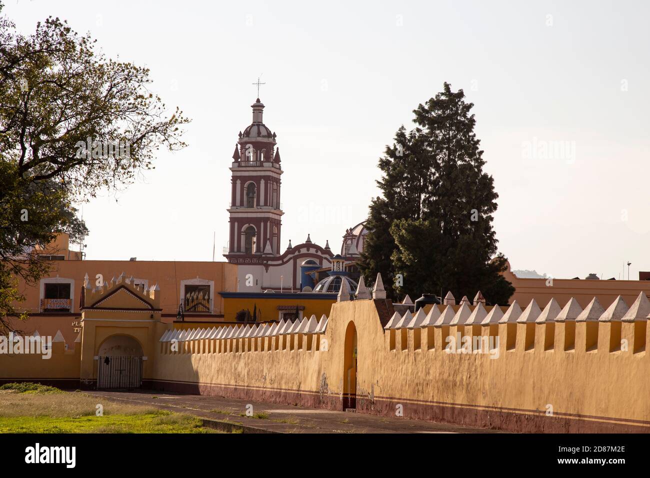 Monastery wall and catholic church in background, during golden hour ...