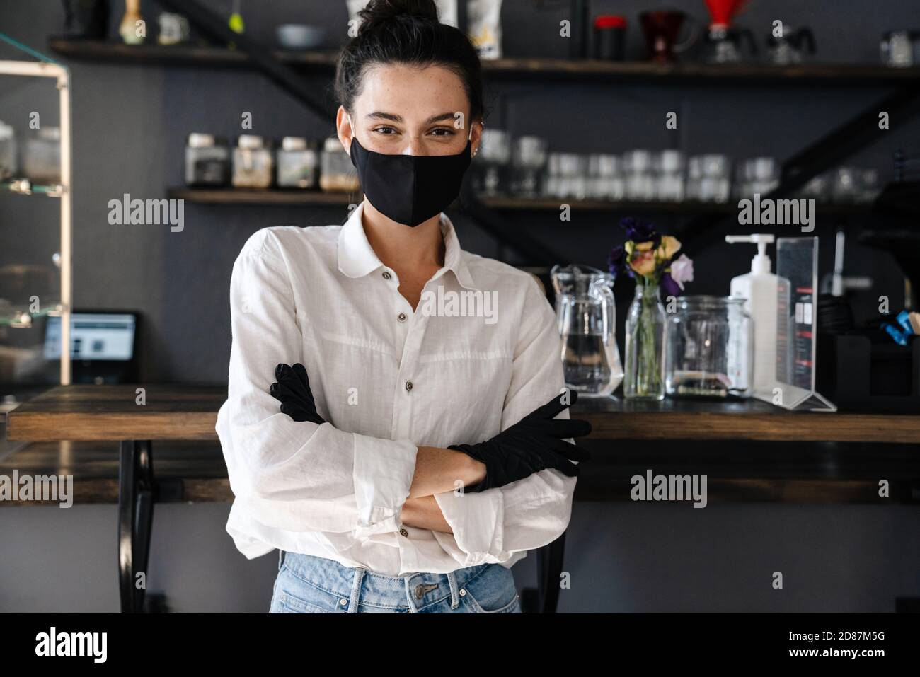 Business owner and barista wearing face mask and smiling after ...