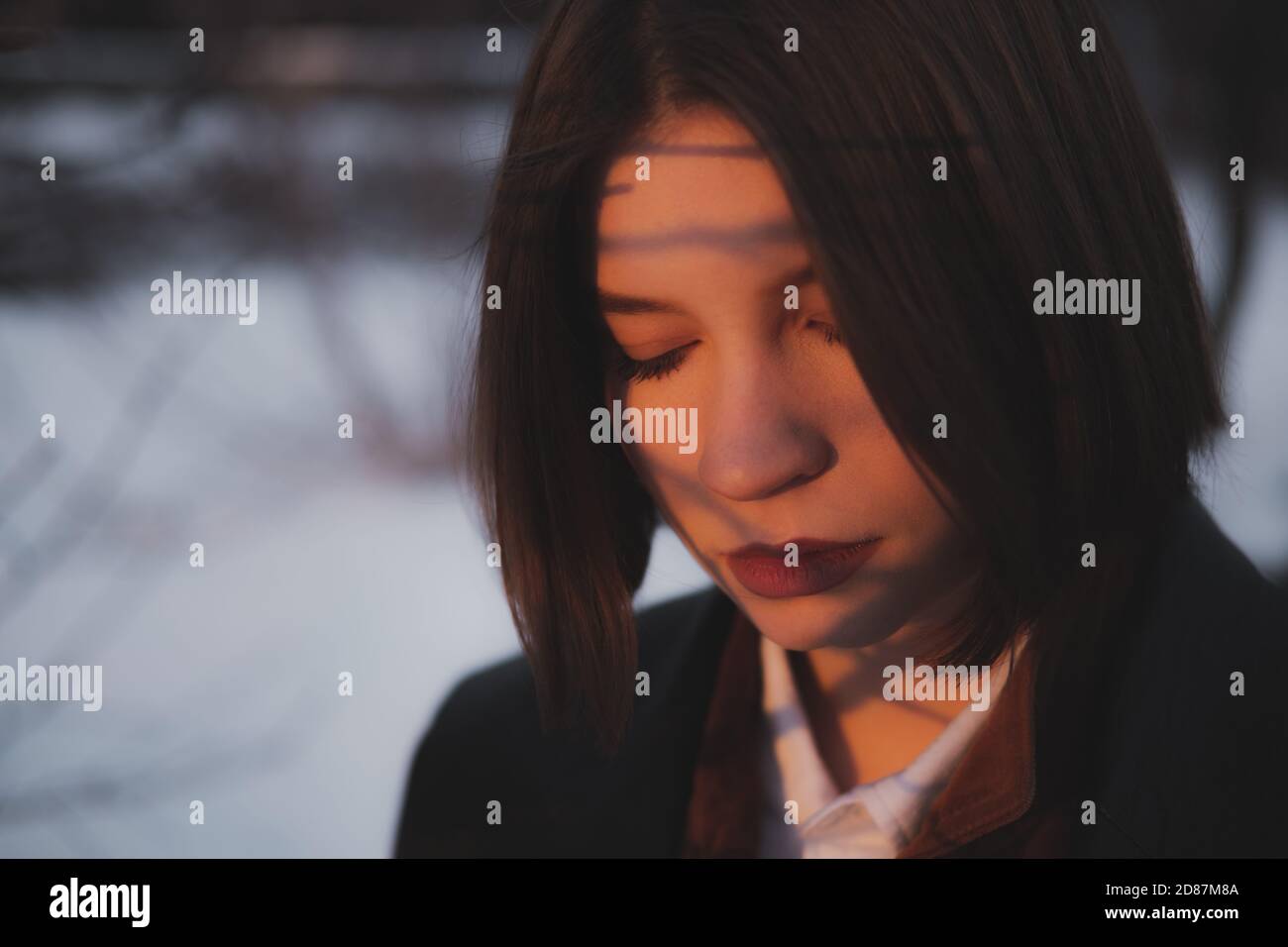 Portrait of young attractive woman, shadows on the face, direct ...