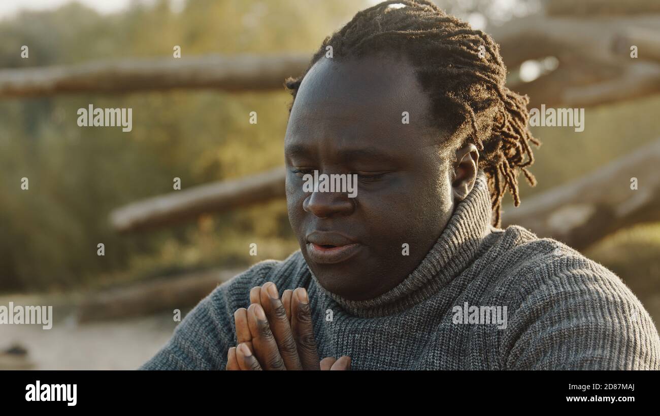 Young african man praying in the nature. High quality photo Stock Photo ...