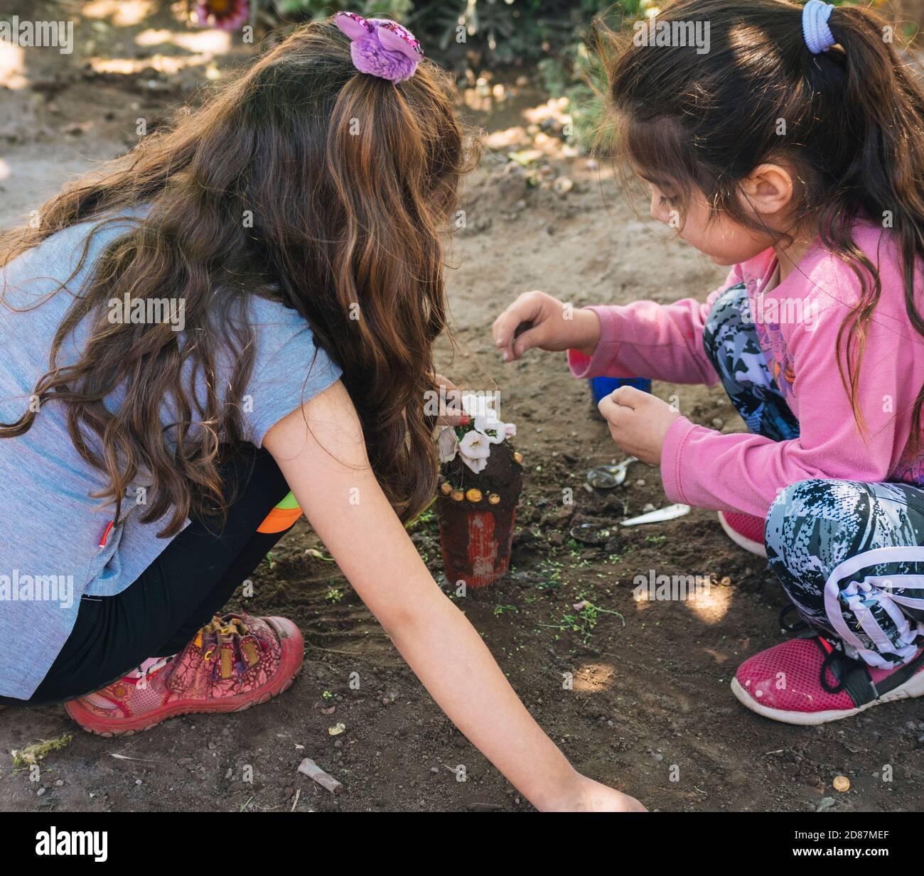 little girls playing with mud Stock Photo - Alamy