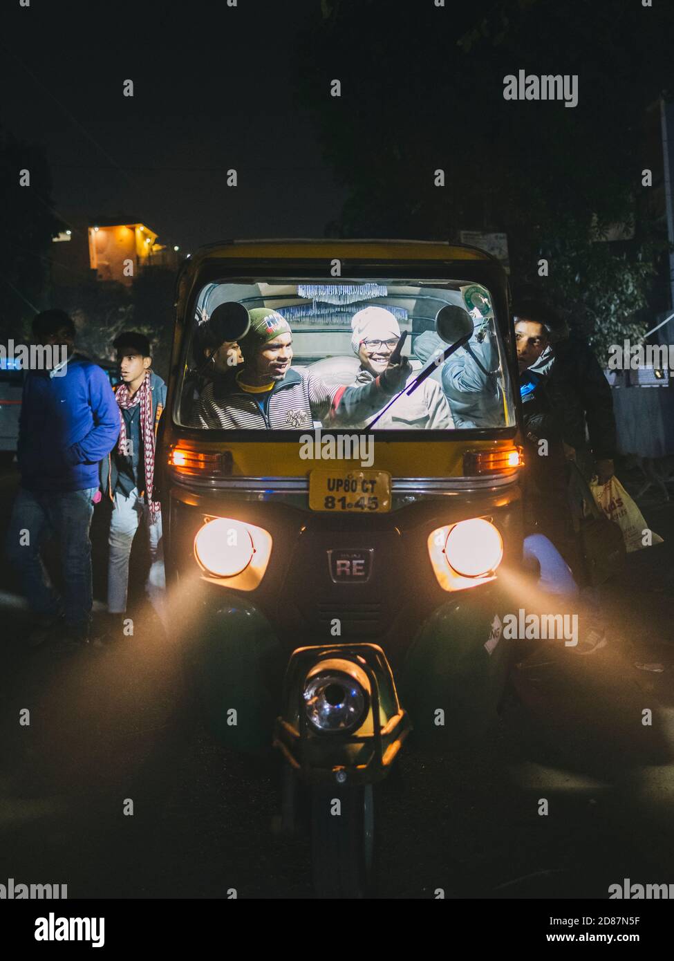 Tuk Tuk, also known as Auto, picking Indian young man at night time in ...